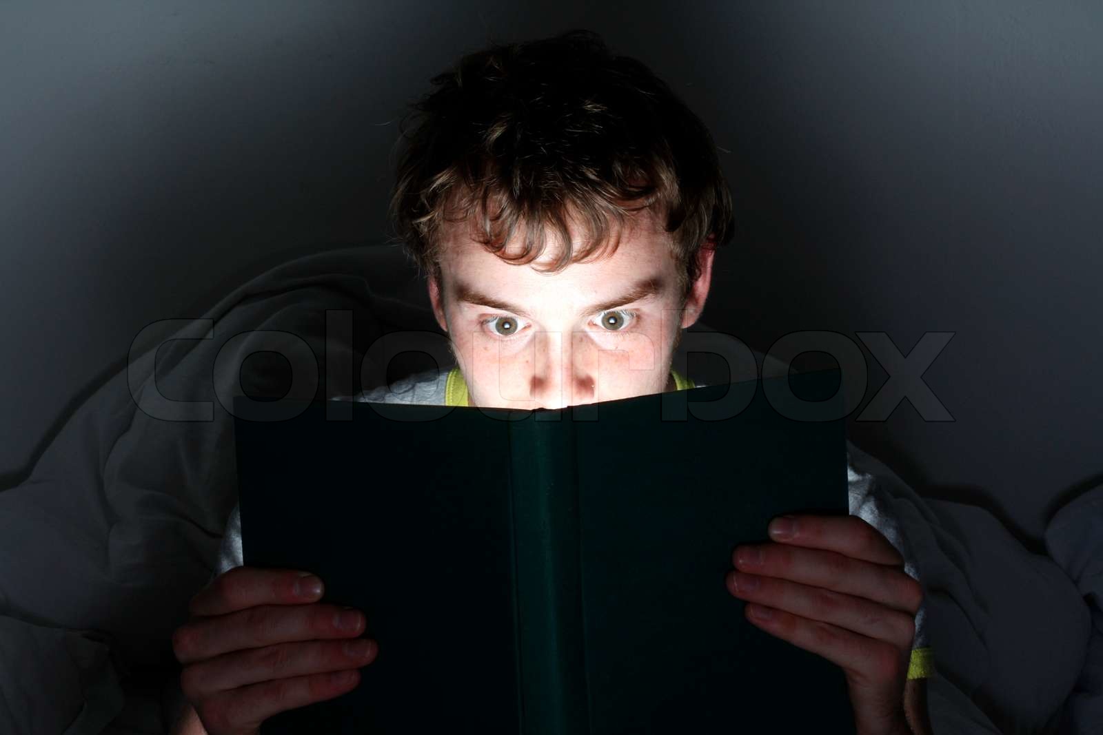 A man engrossed in reading a book | Stock image | Colourbox