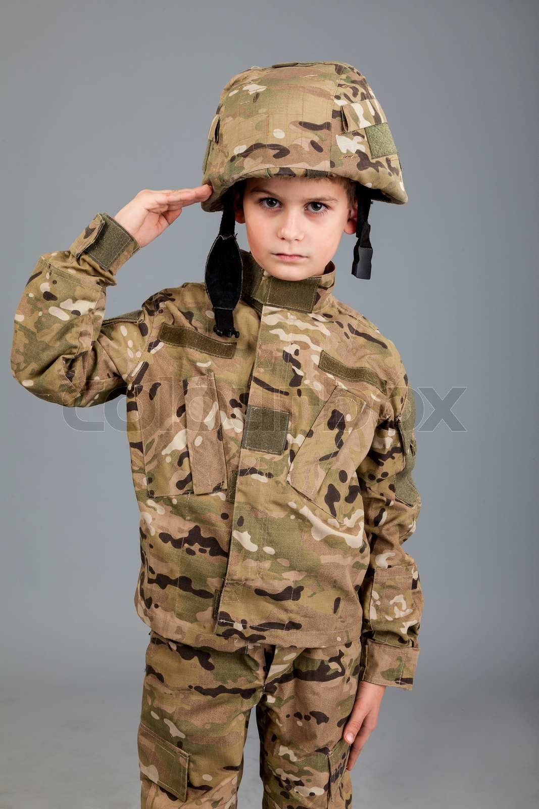 Saluting soldier. Young boy dressed like a soldier | Stock image ...