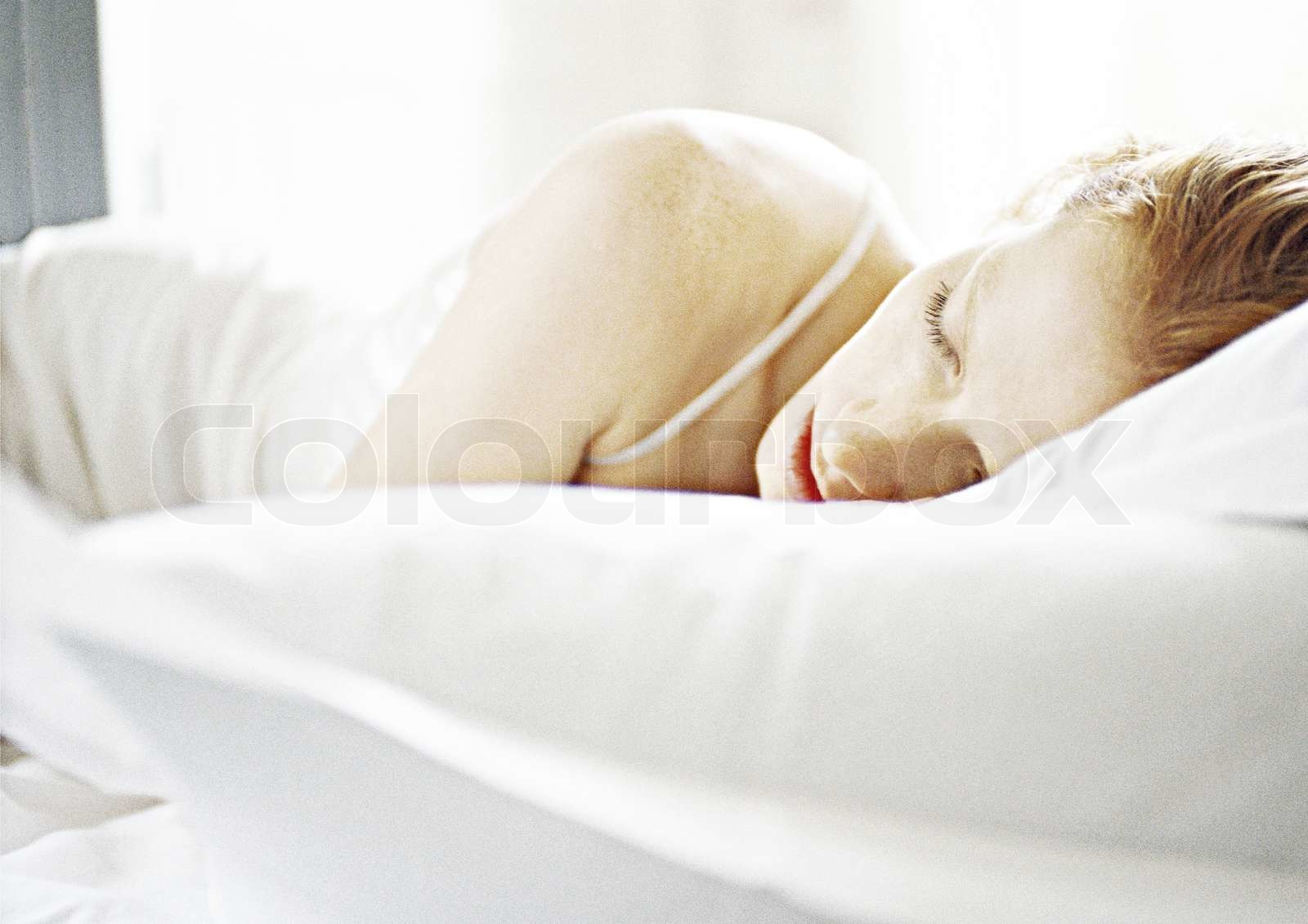 Woman lying in bed, close up. | Stock image | Colourbox