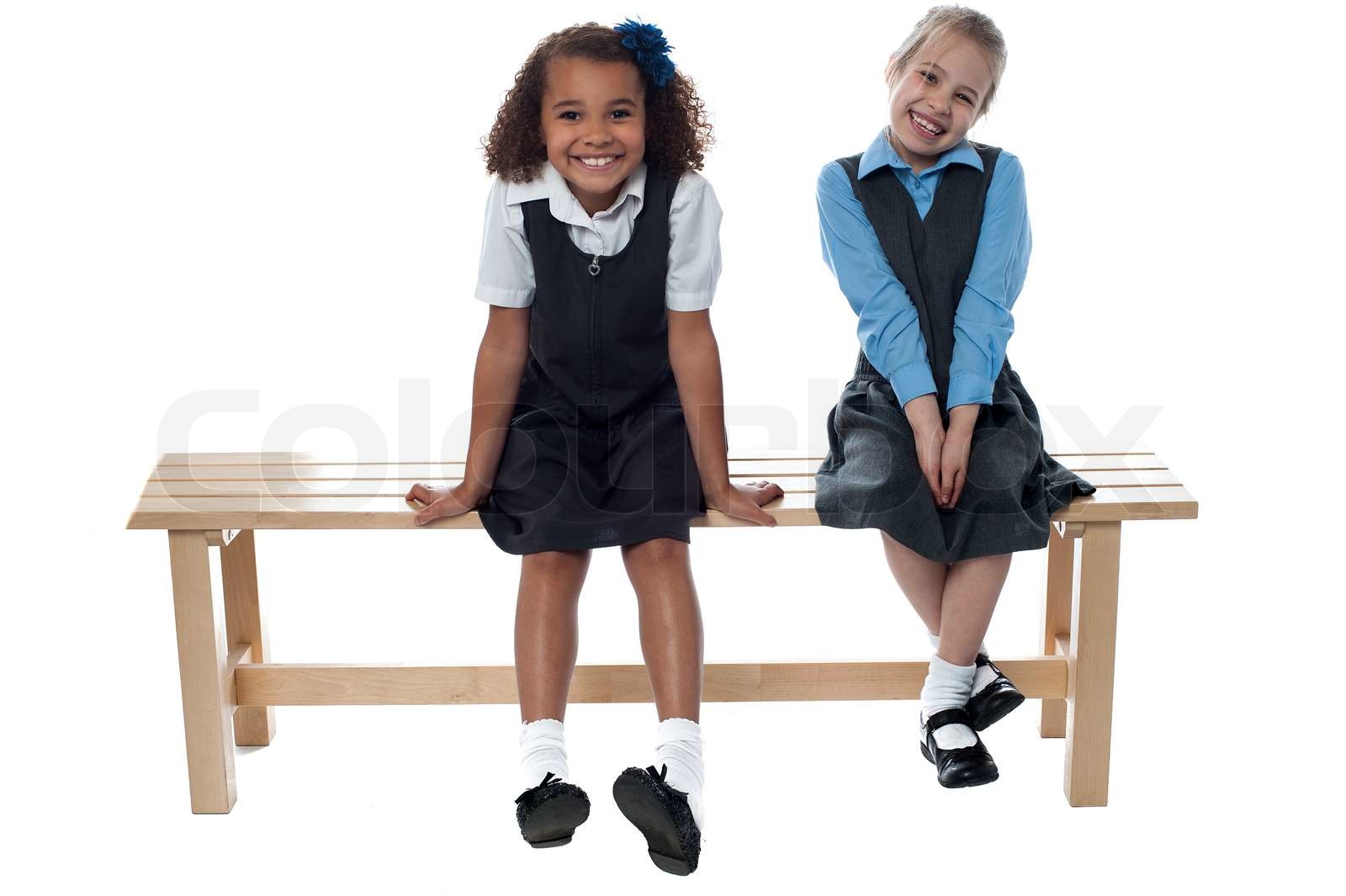 Little girls sitting on the bench | Stock image | Colourbox