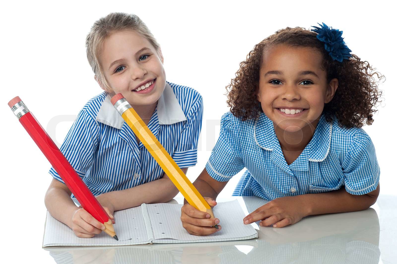 Kids writting their assignment | Stock image | Colourbox