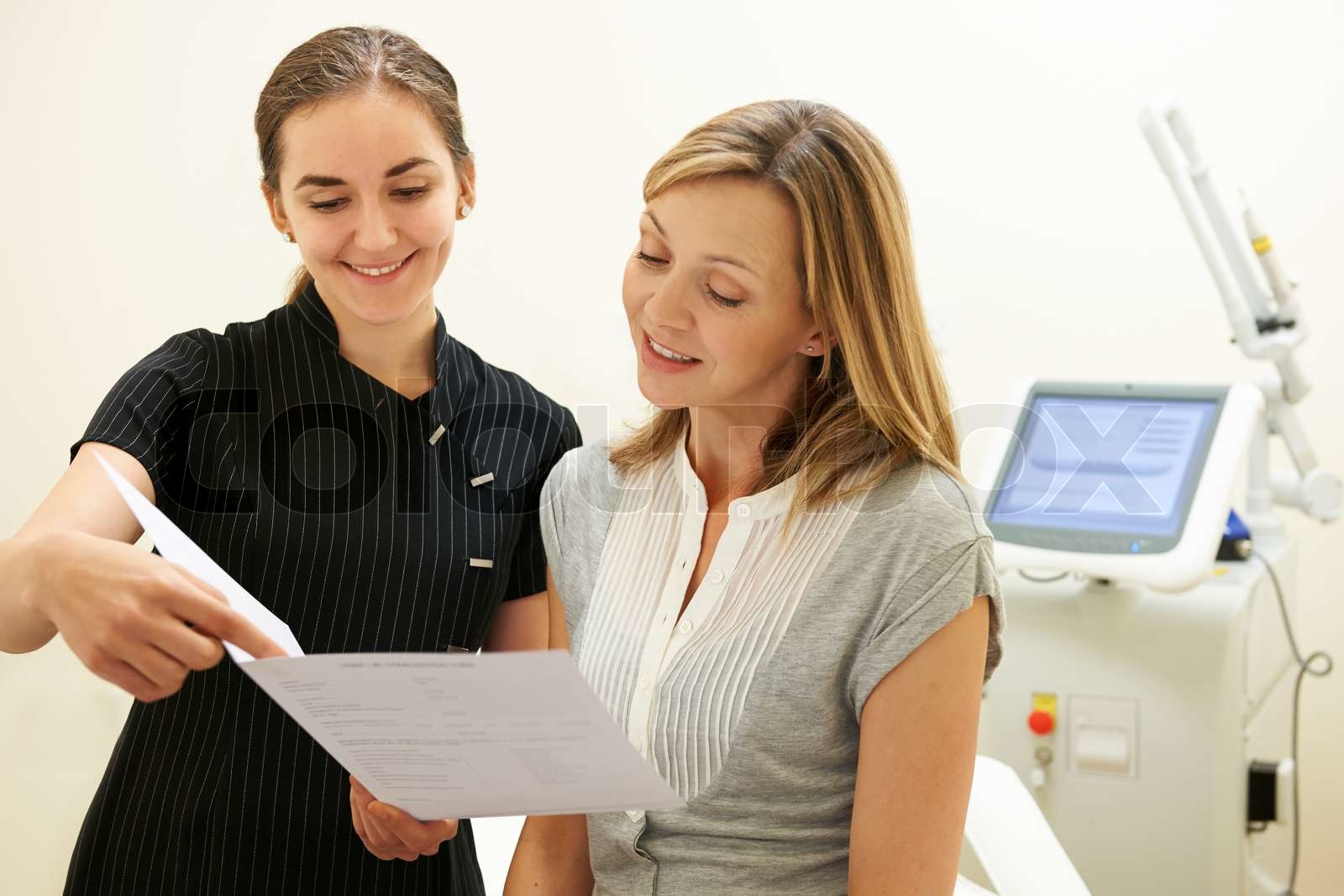 Beautician Discussing Traetment With Female Client Stock Image
