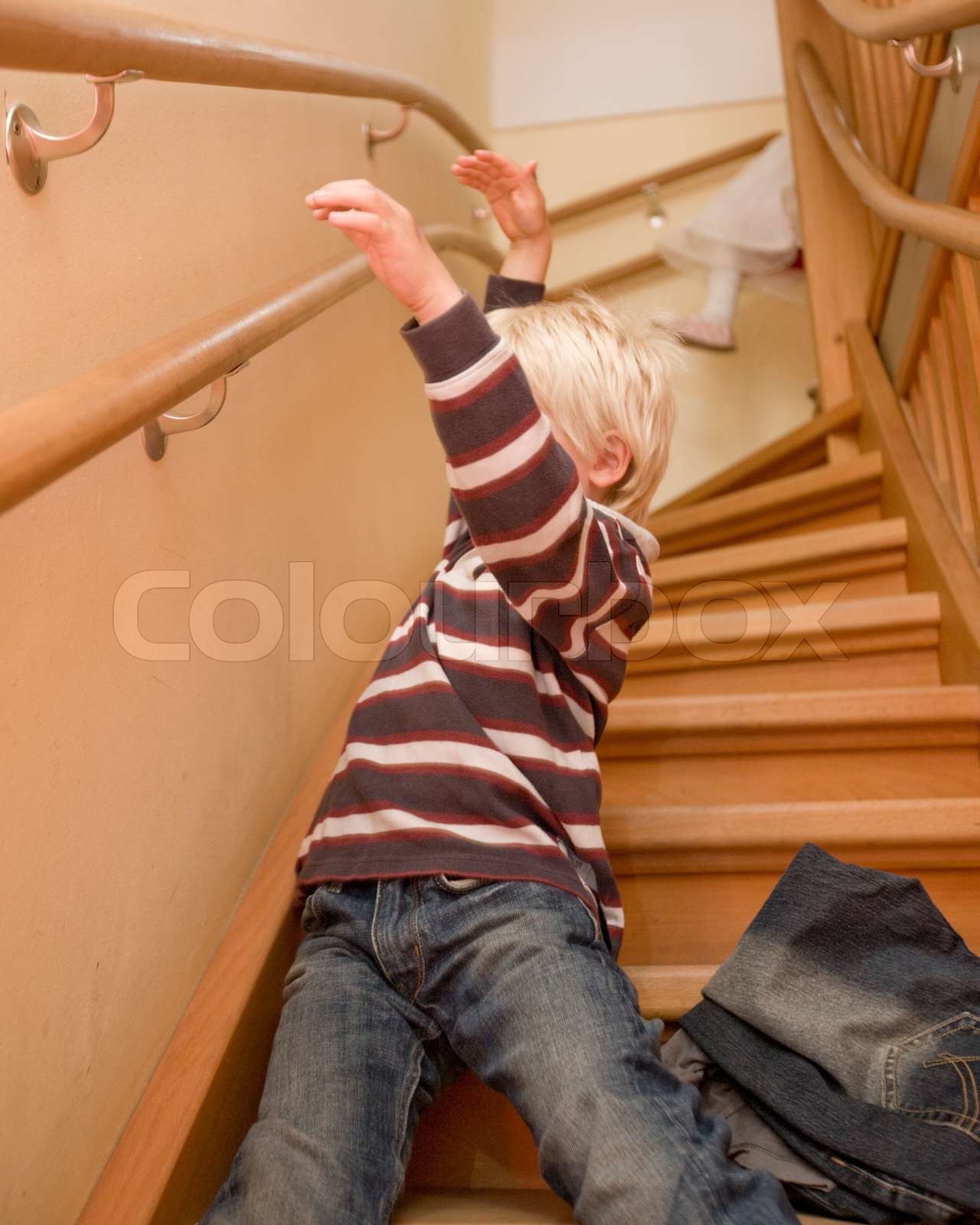 A young boy falling from a staircase | Stock image | Colourbox