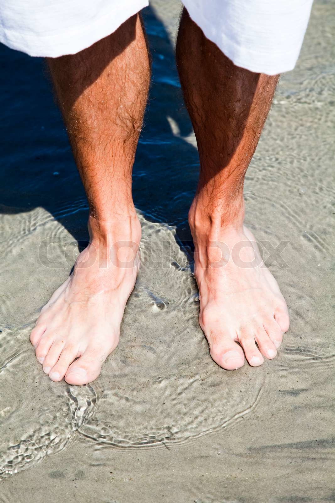 A man's feet on the beach | Stock image | Colourbox