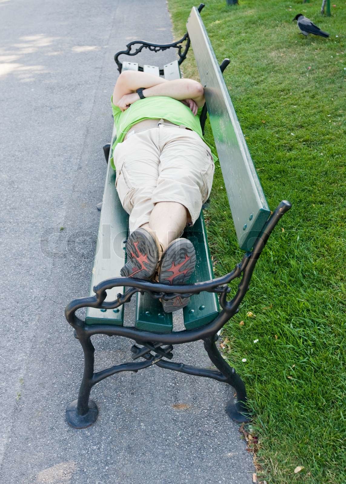 A man sleeping on a park bench | Stock image | Colourbox