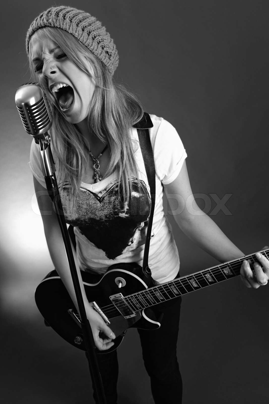 Guitarist screaming into old microphone | Stock image | Colourbox