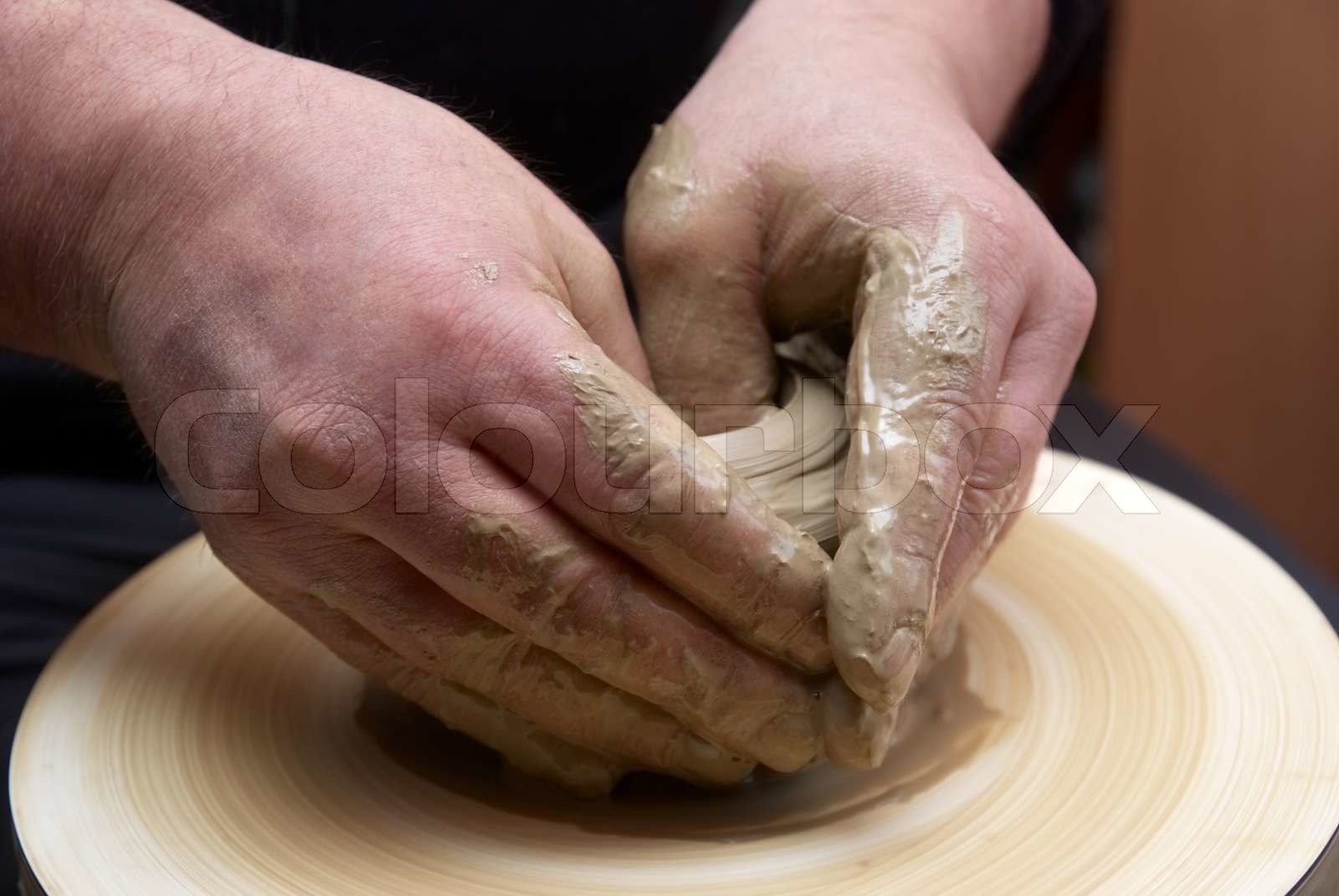 Hands forming clay pot | Stock image | Colourbox