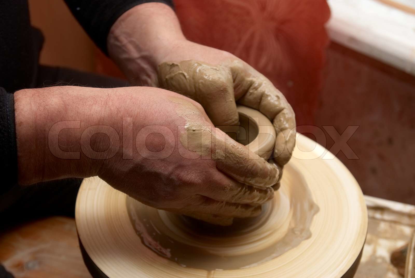 Hands forming clay pot | Stock image | Colourbox