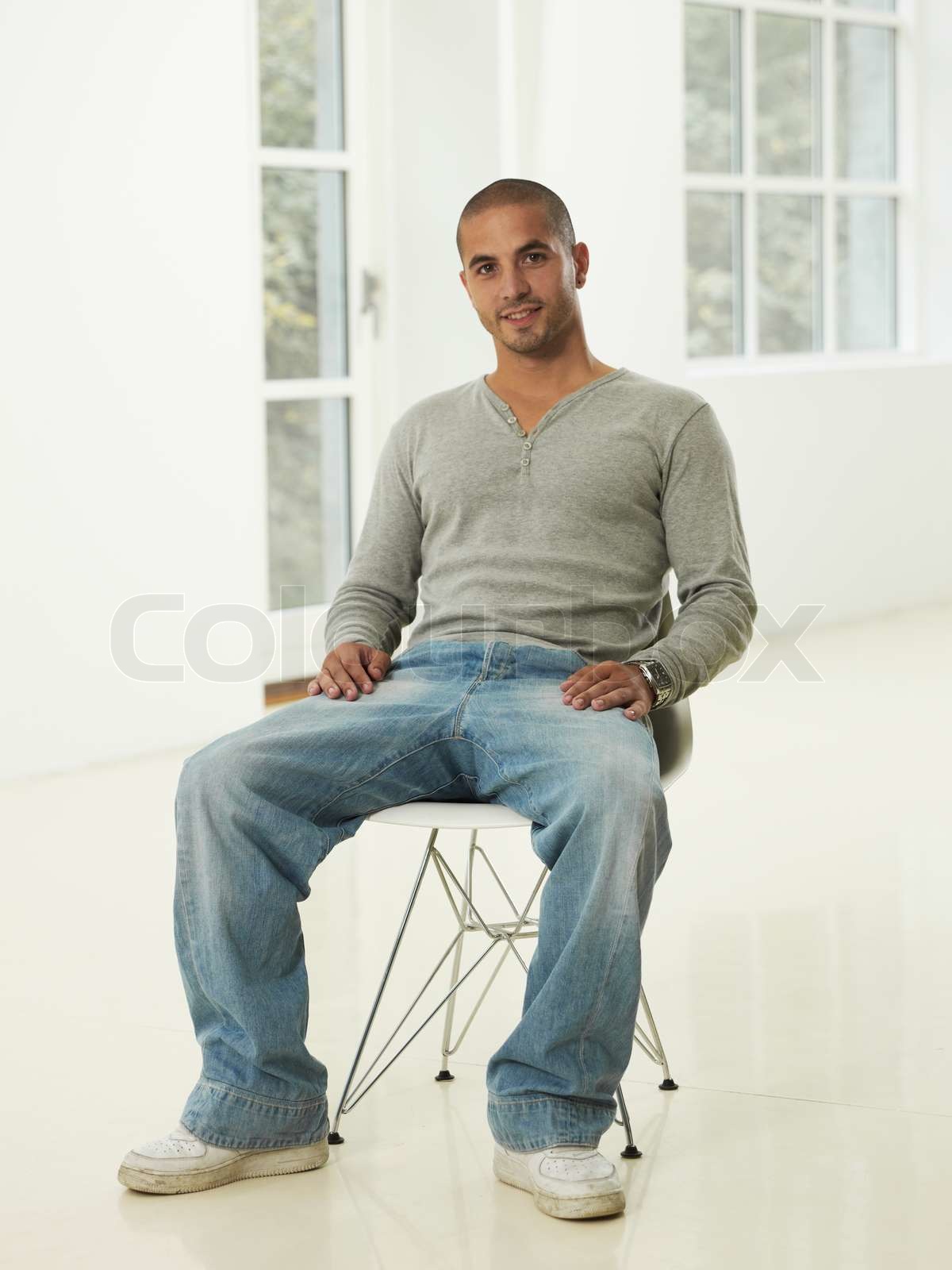 Portrait of a man sitting on a chair | Stock image | Colourbox
