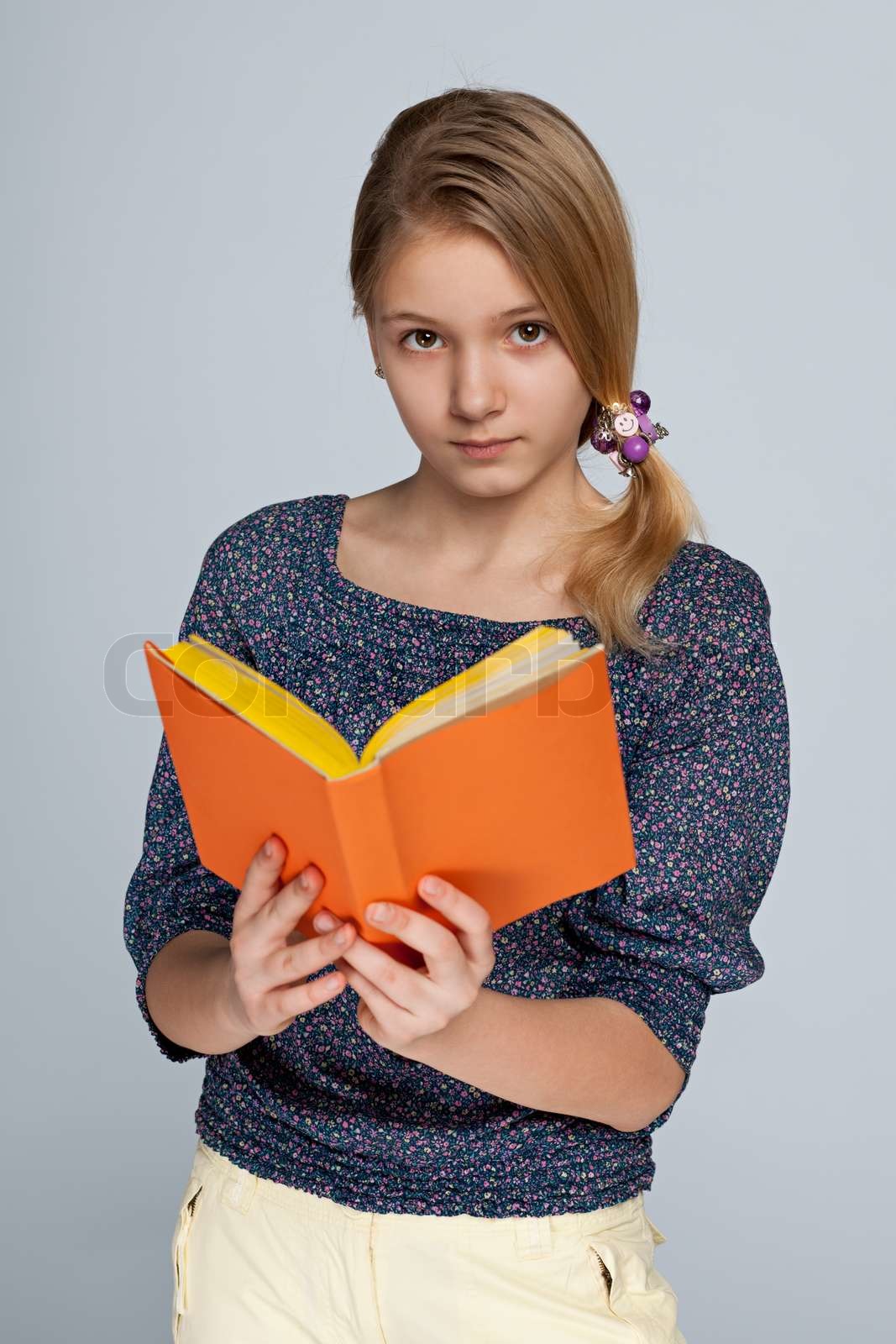 Clever young girl with a book | Stock image | Colourbox