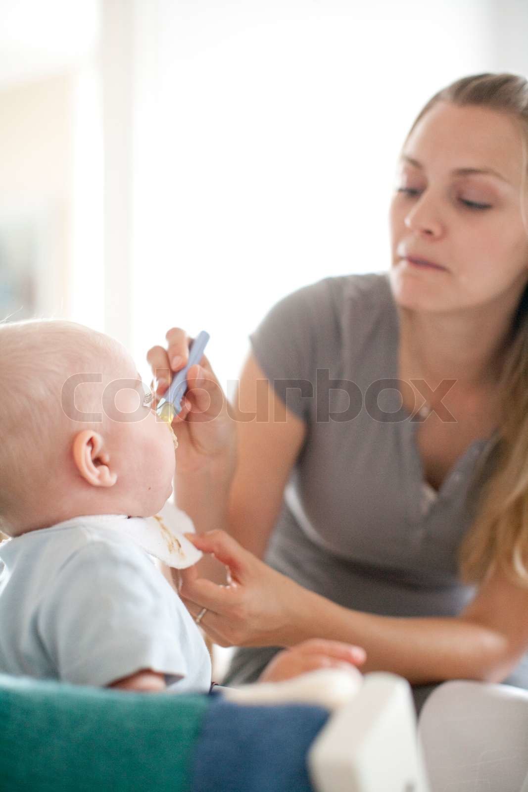 A baby boy being fed by his mother | Stock image | Colourbox