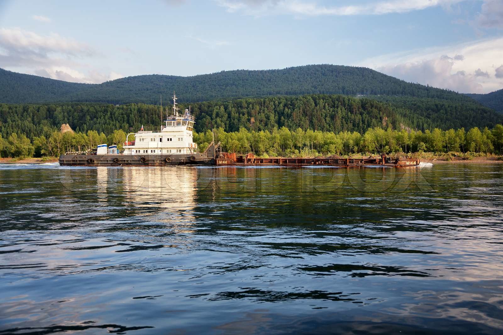 Tugboat pulling a barge | Stock image | Colourbox