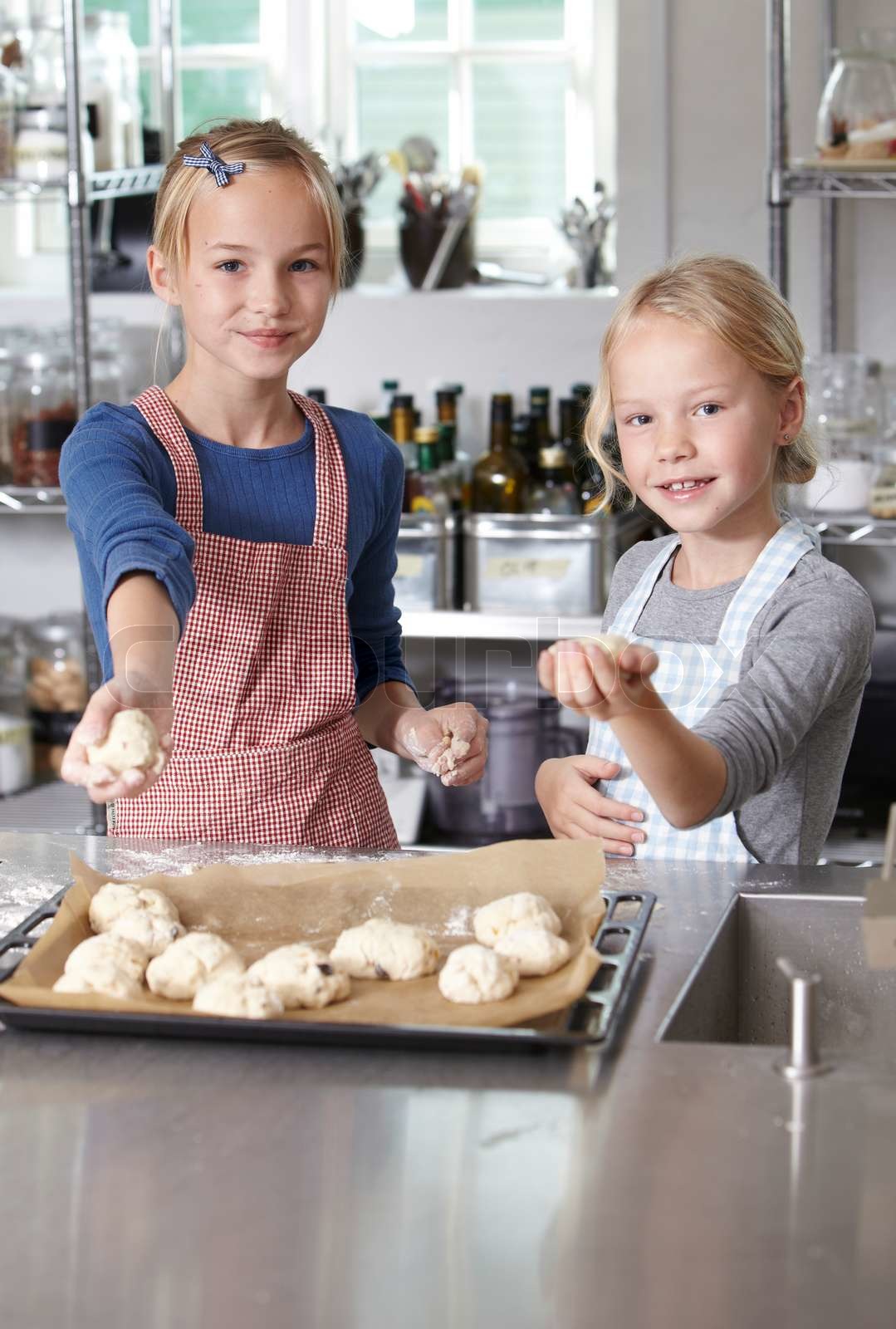 Two girls baking cookies | Stock image | Colourbox