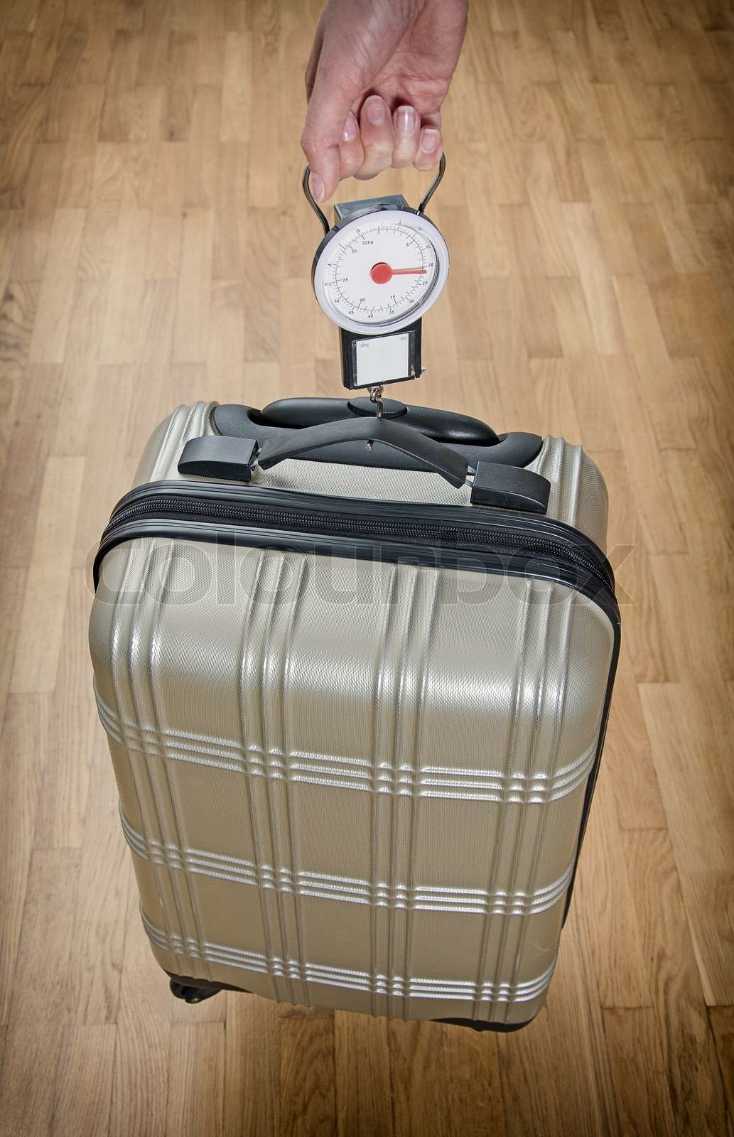 Hand luggage measurement using steelyard balance. | Stock image | Colourbox
