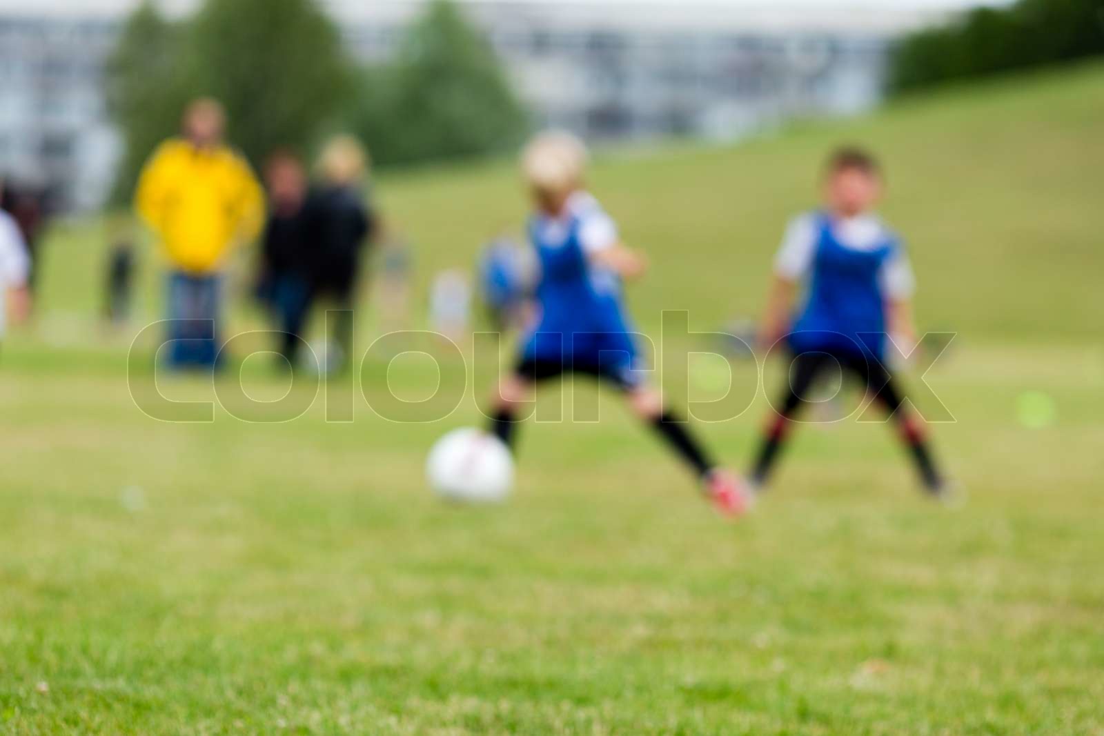 Blurred kids on soccer pitch | Stock image | Colourbox