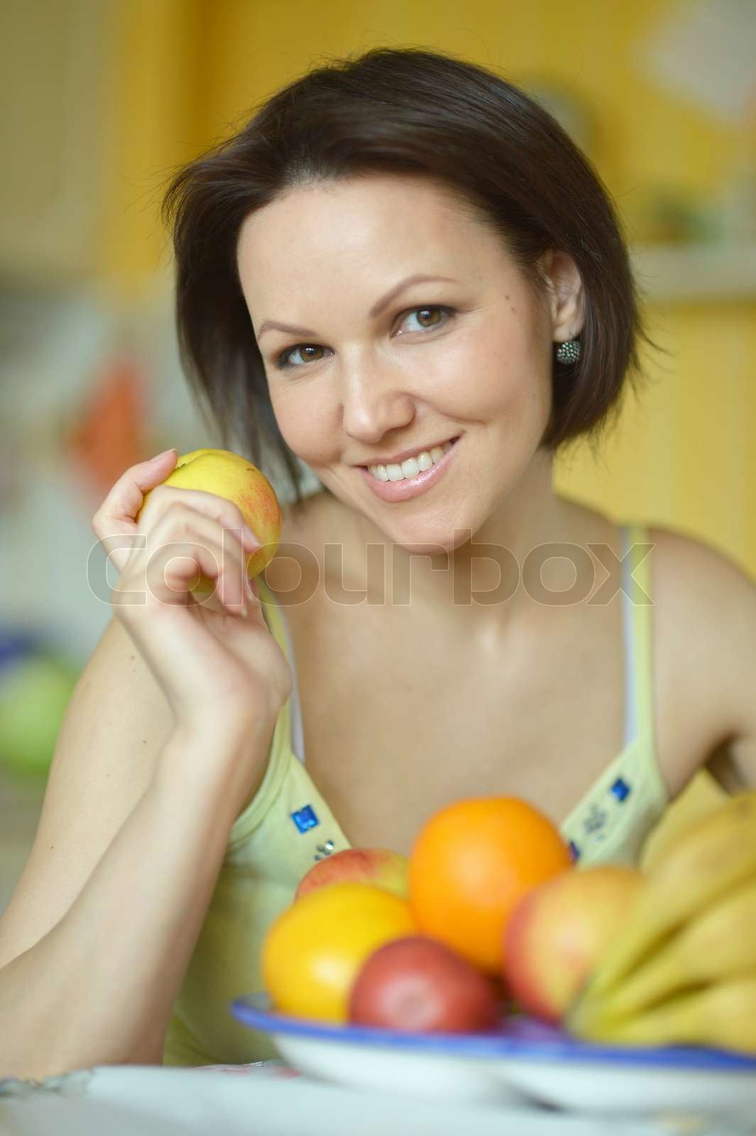 Woman eating fruits | Stock image | Colourbox