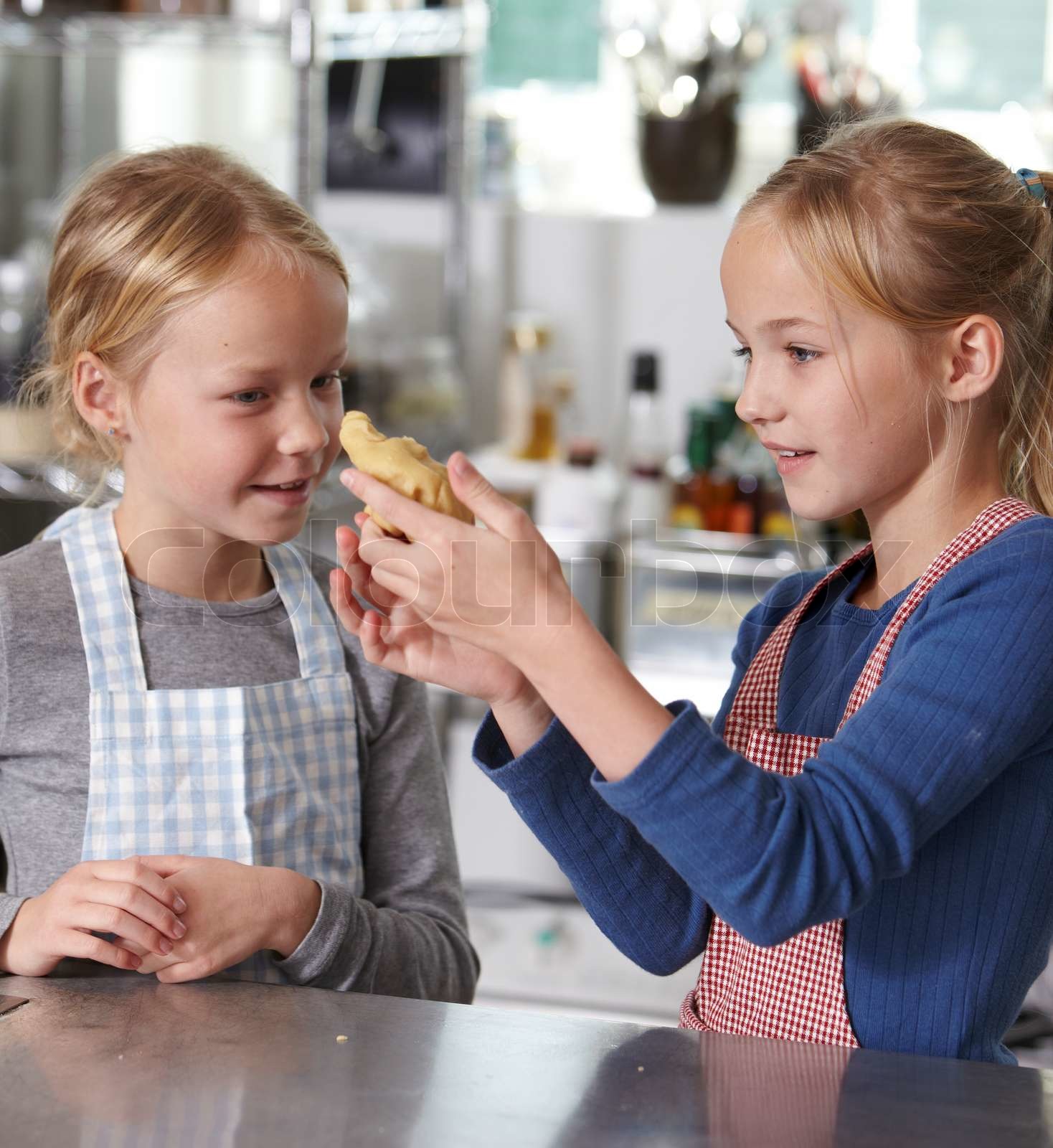 Two girls playing with cookie dough | Stock image | Colourbox