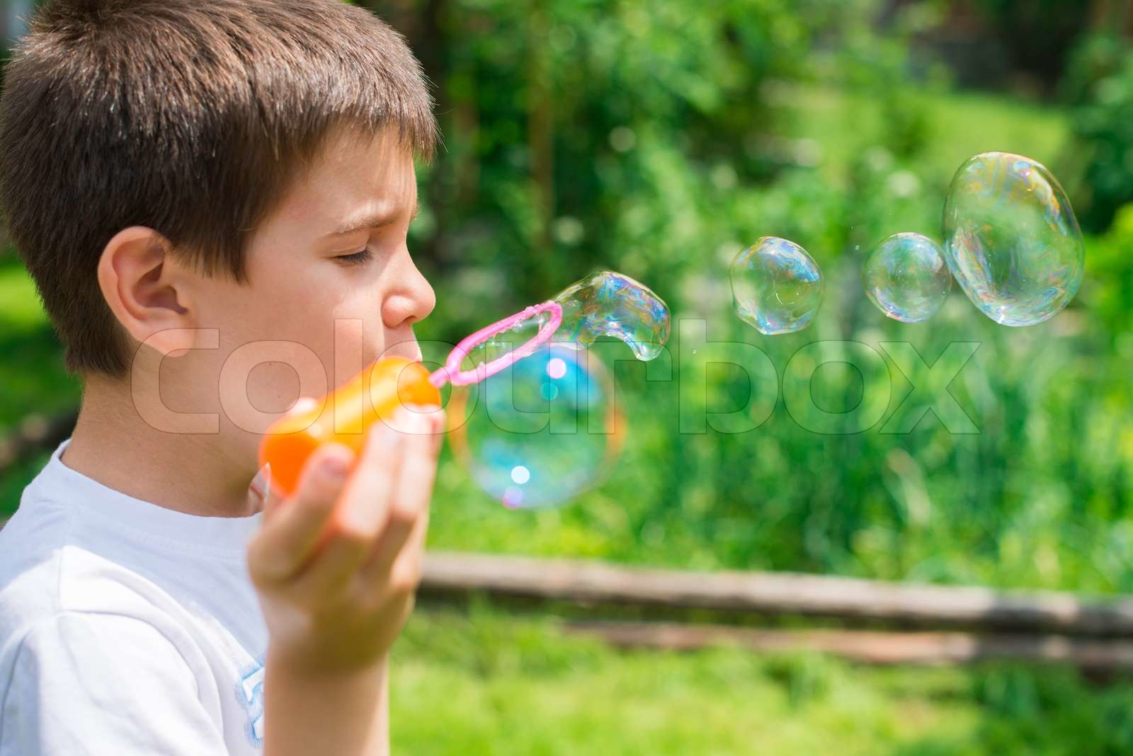 Child makes bubbles | Stock image | Colourbox