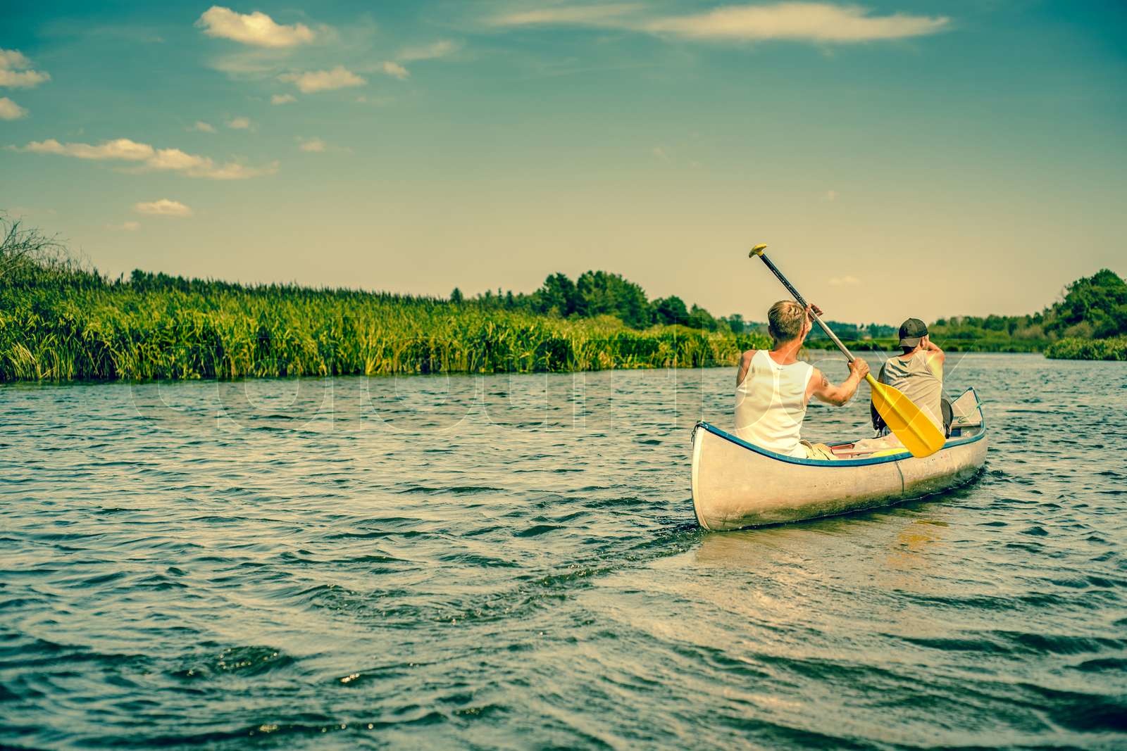 Men canoeing down a river stream | Stock image | Colourbox