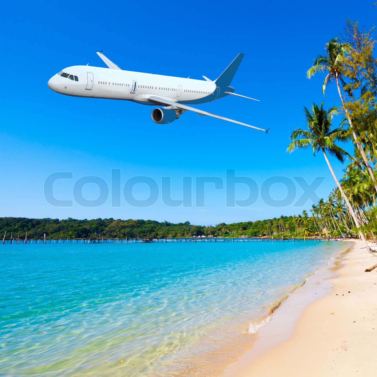 Jet plane over the tropical sea | Stock image | Colourbox