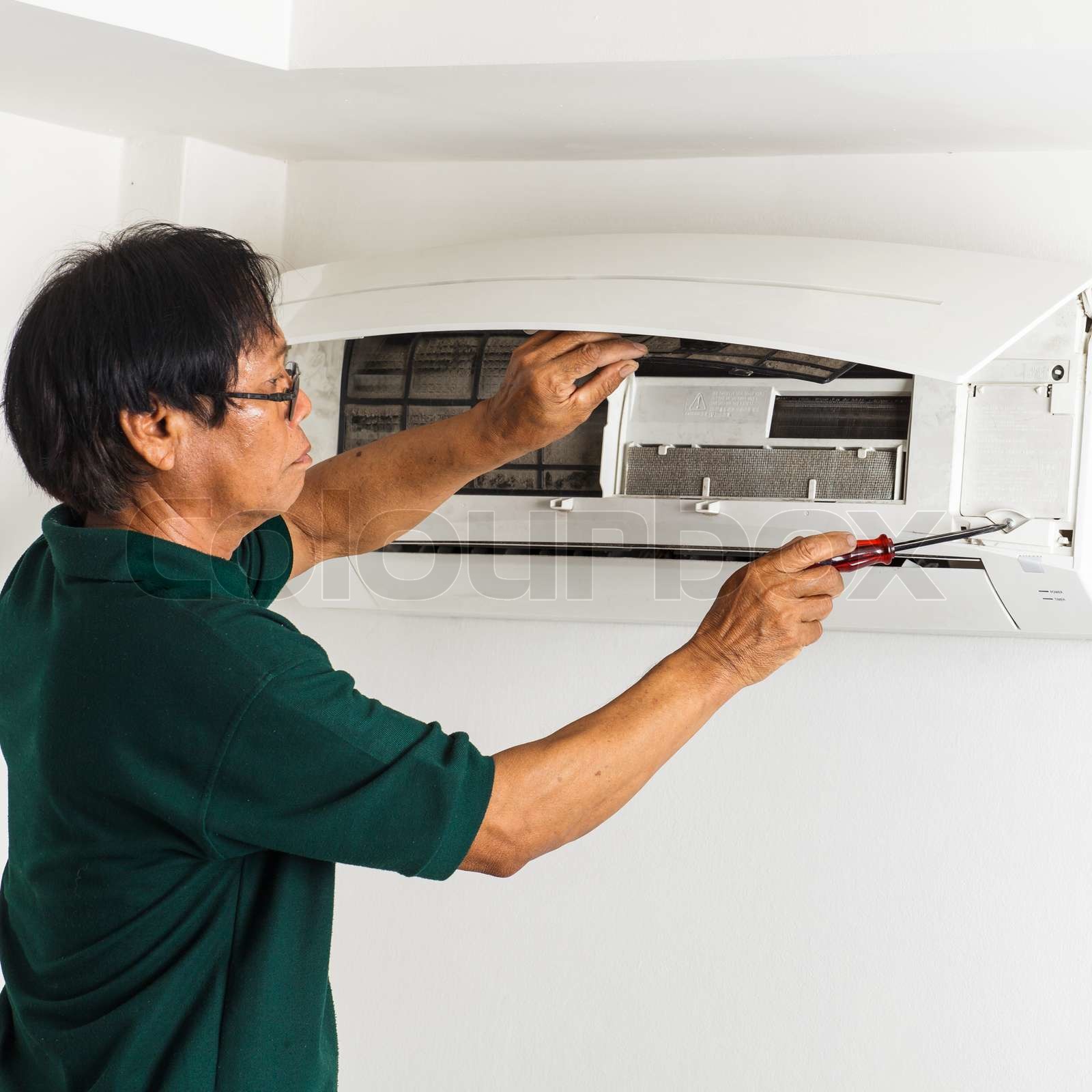 man repair air conditioner | Stock image | Colourbox