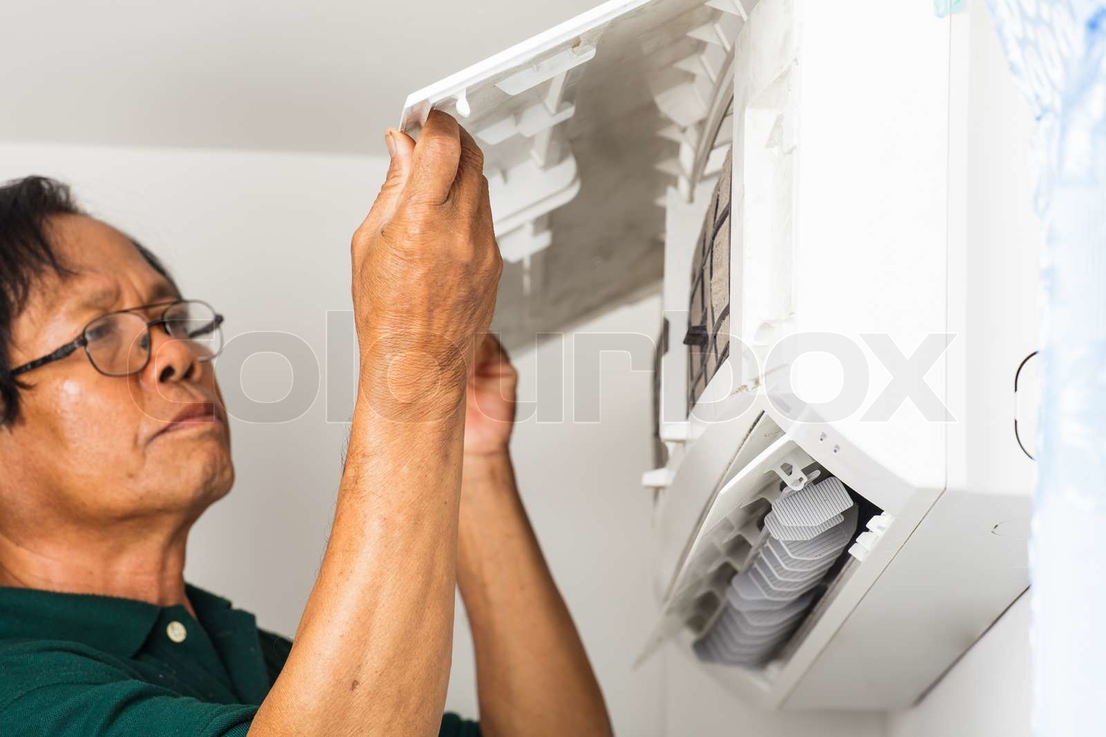 man repair air conditioner | Stock image | Colourbox