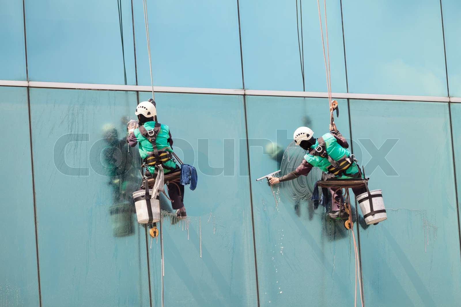 group of workers cleaning windows service on high rise building | Stock ...