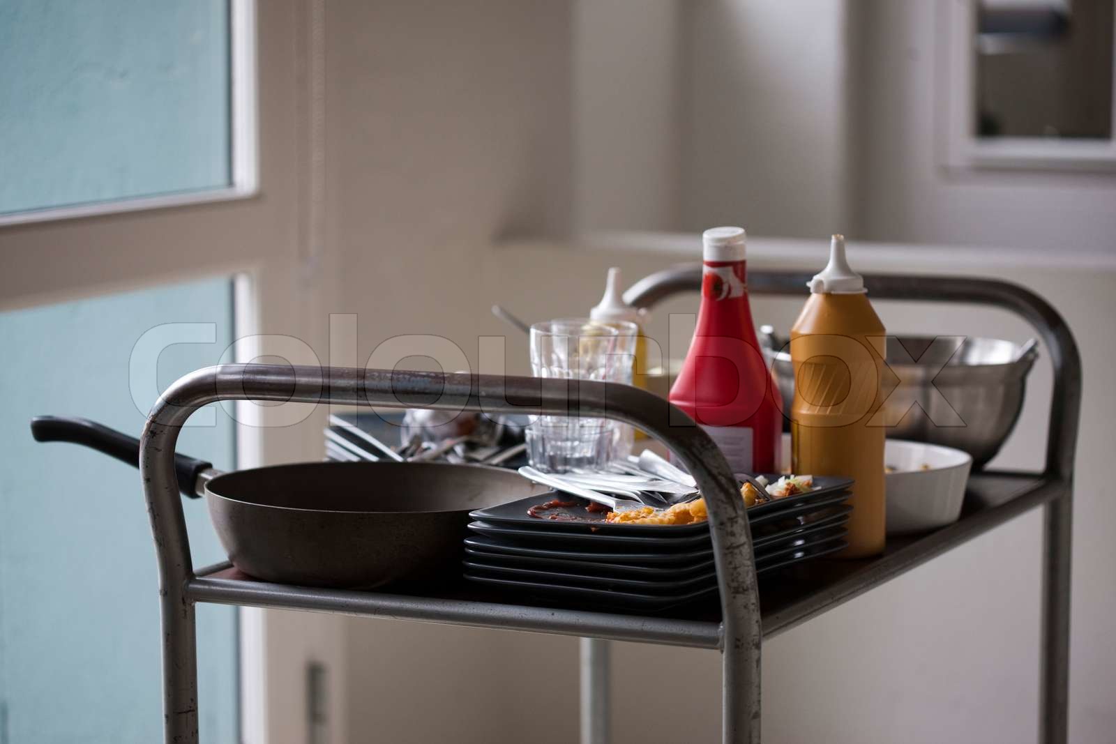 Food trolley with dirty plates and condiments | Stock image | Colourbox