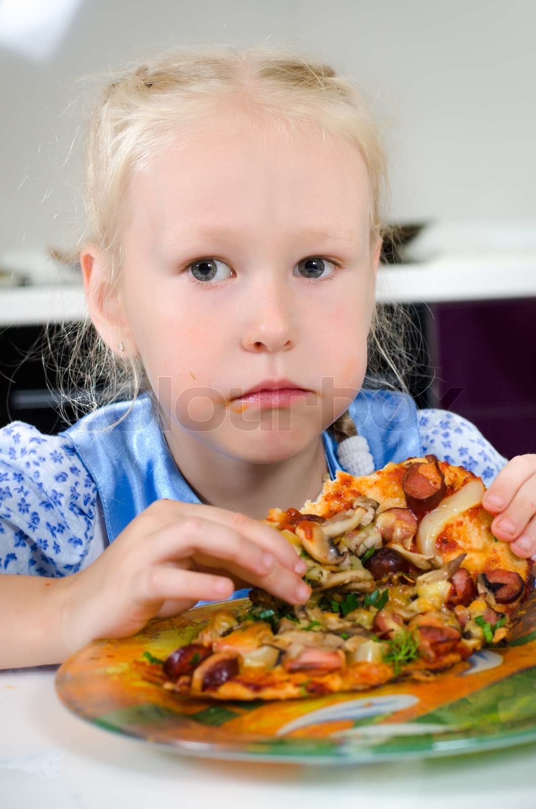 Starving young girl eating | Stock image | Colourbox