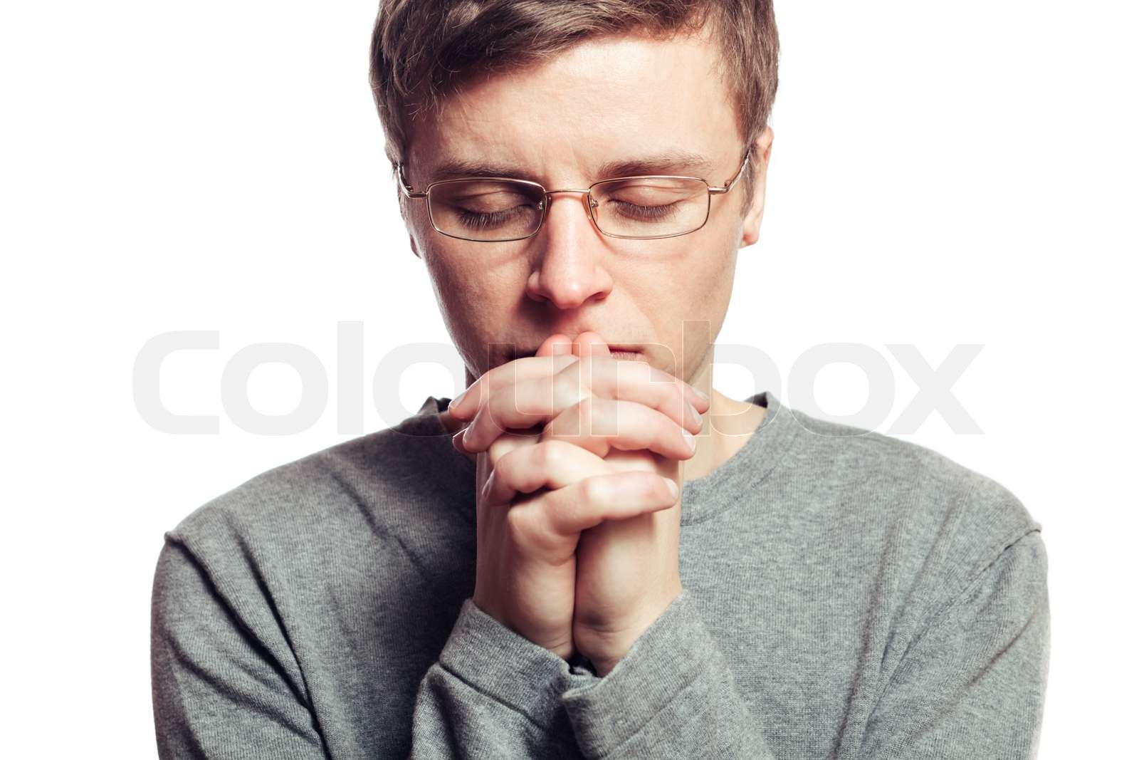Young man praying | Stock image | Colourbox