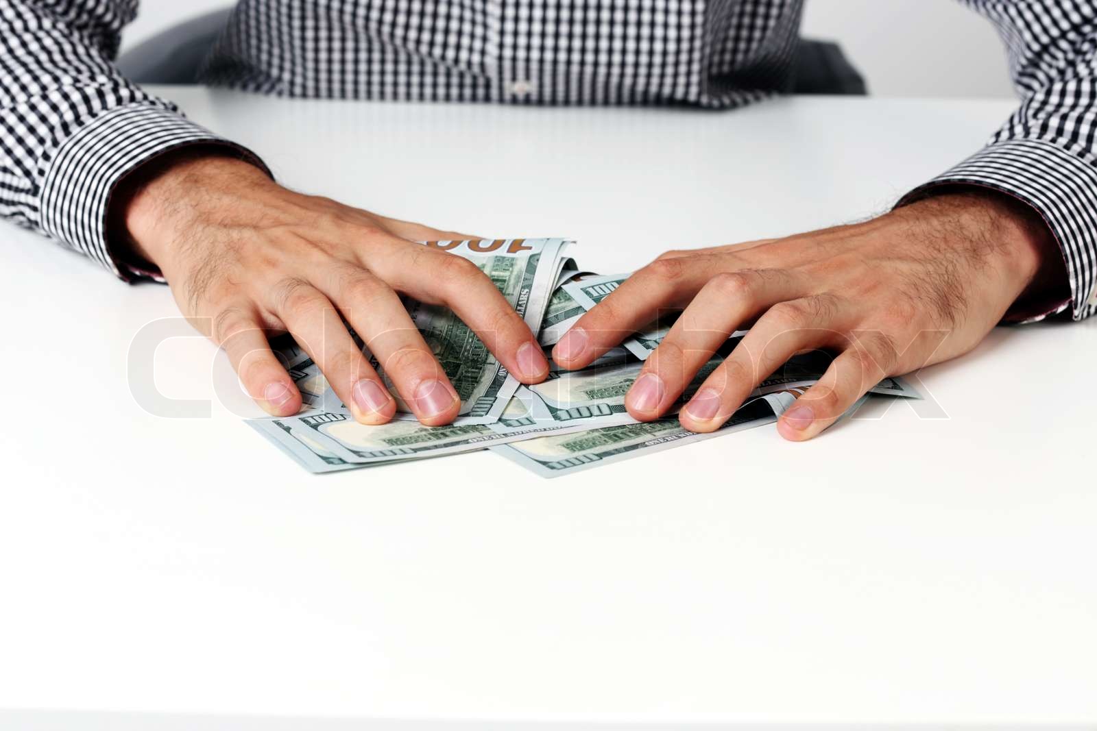 Closeup of a male hands hold dollars on the table | Stock image | Colourbox