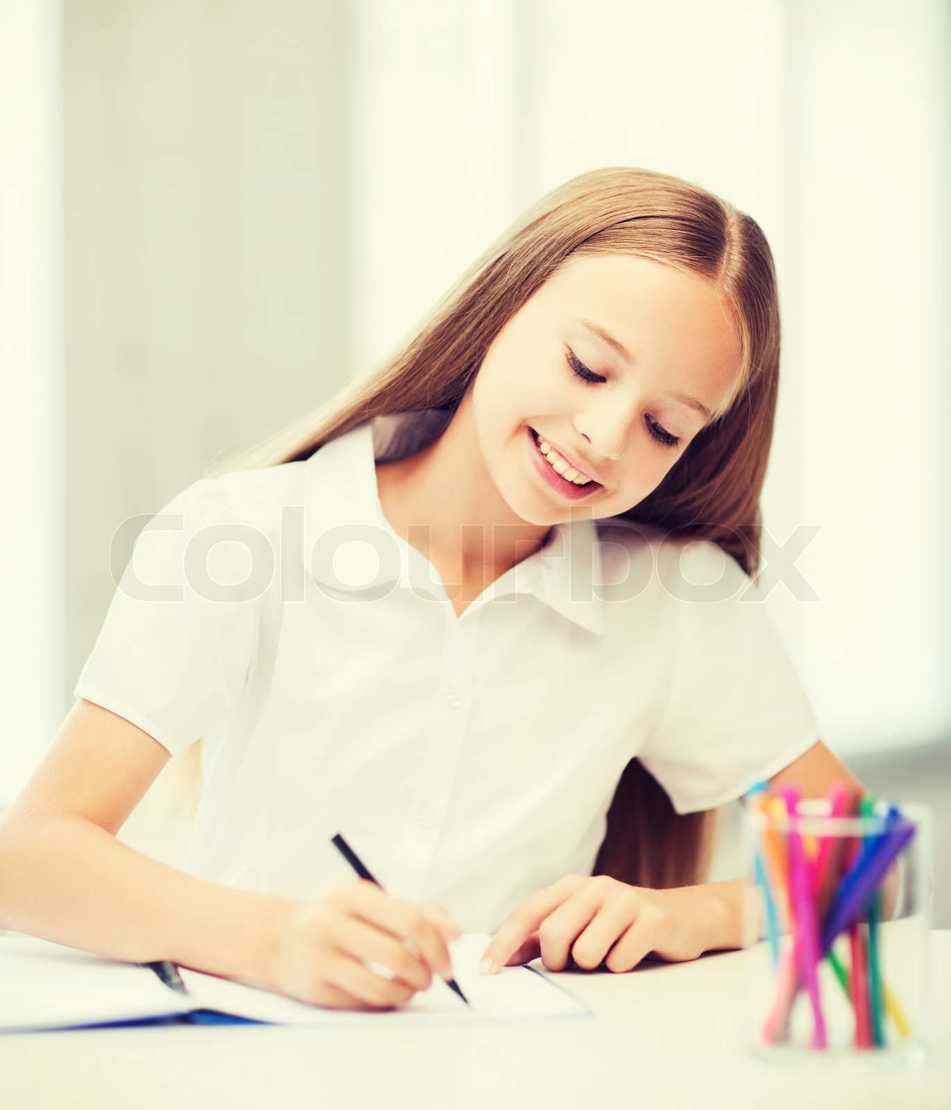 little student girl drawing at school | Stock image | Colourbox