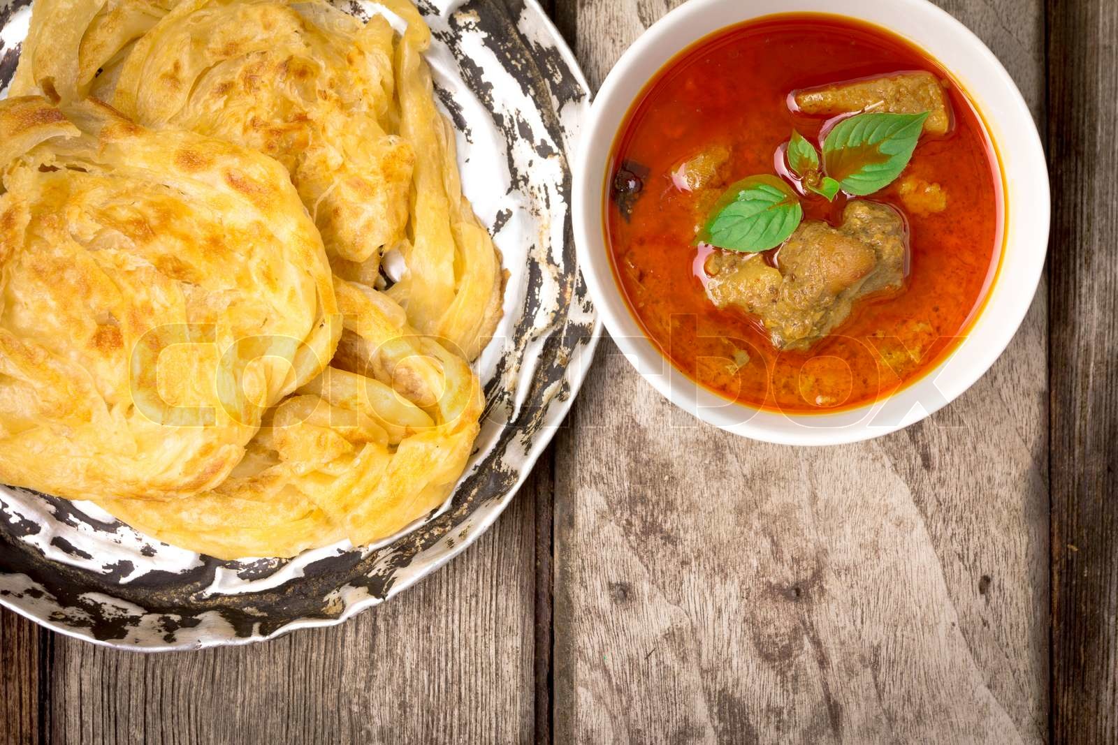 roti canai with spicy curry | Stock image | Colourbox