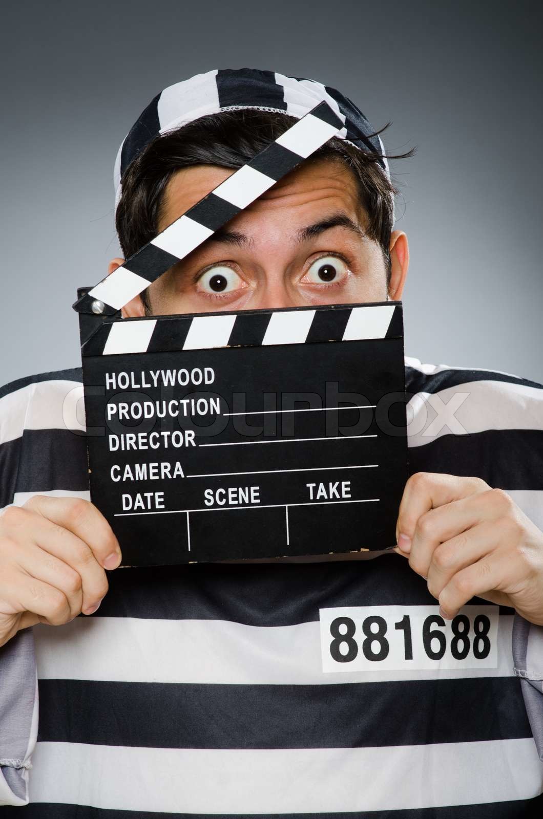 Inmate with movie clapper board | Stock image | Colourbox