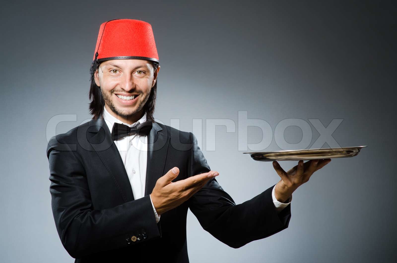 Waiter wearing traditional turkish hat | Stock image | Colourbox