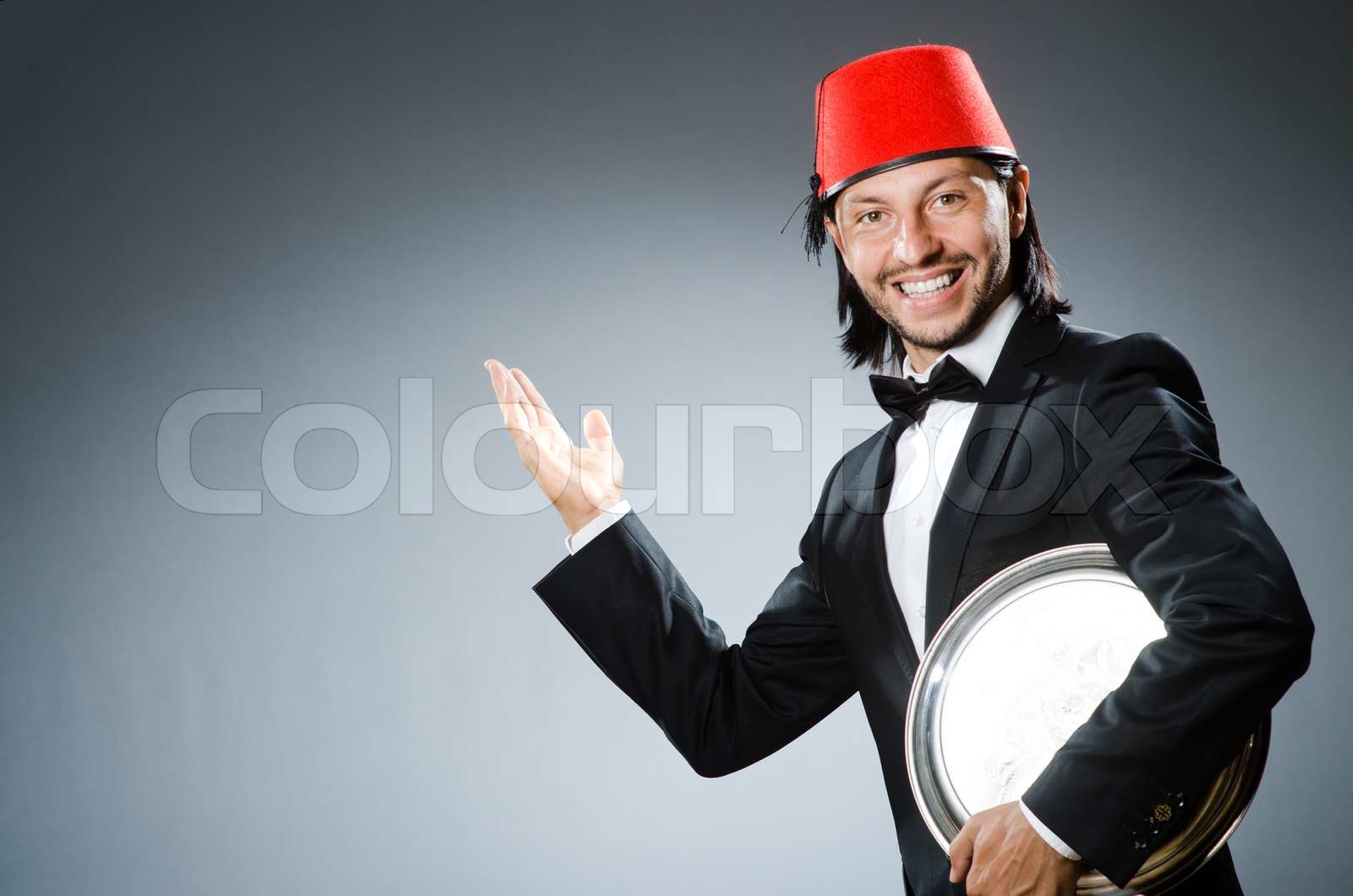 Waiter wearing traditional turkish hat | Stock image | Colourbox