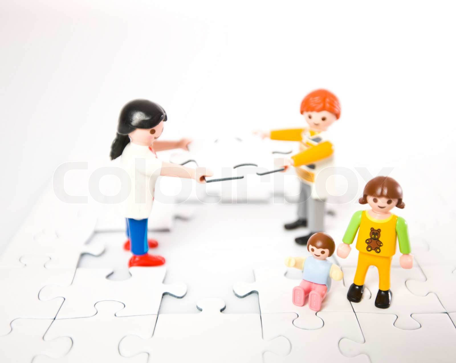 Concept of a family solving a puzzle together | Stock image | Colourbox