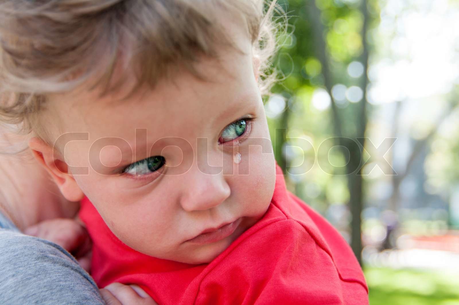 small child crying at the hands of his mother looking back | Stock ...