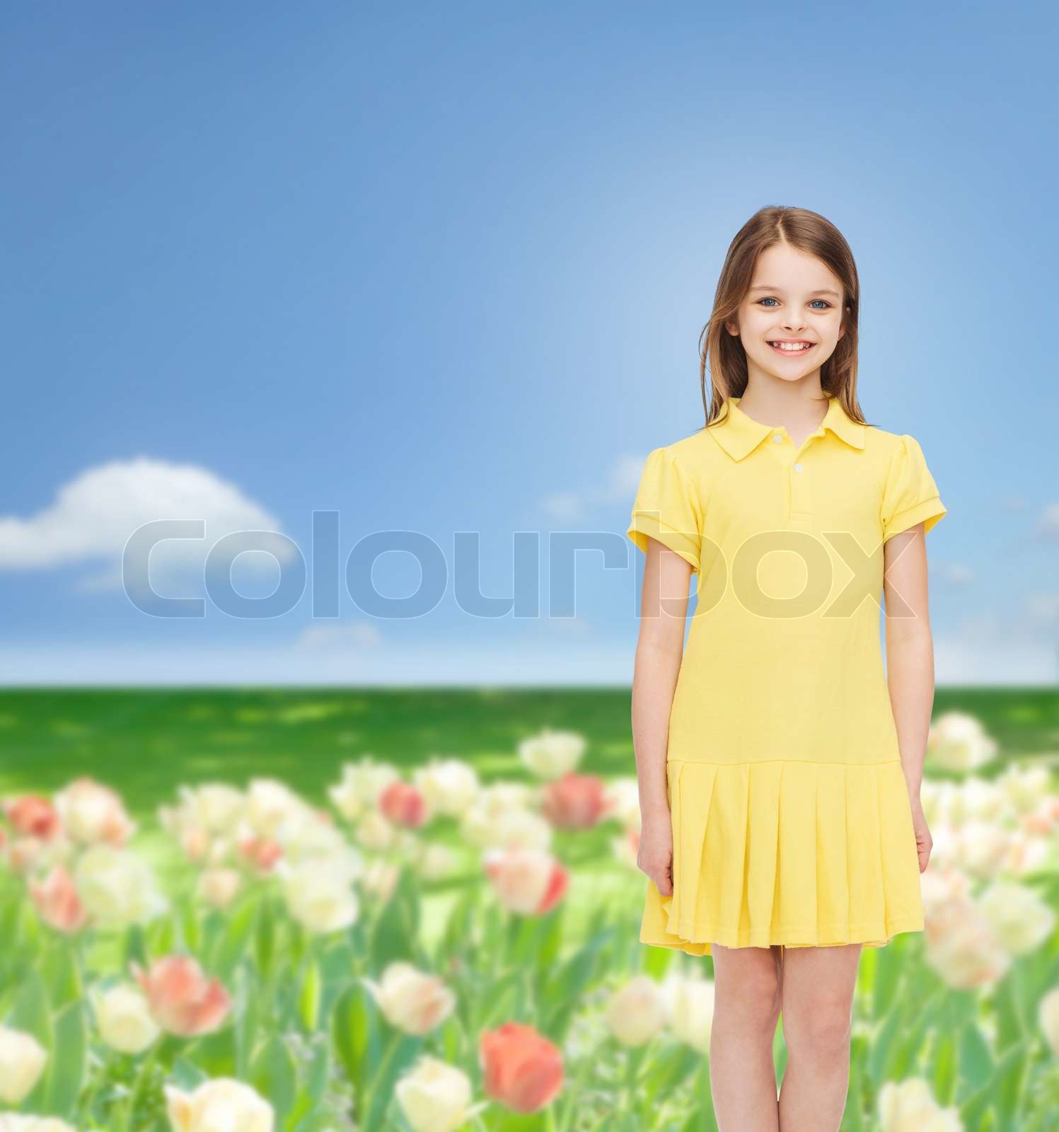 smiling little girl in yellow dress | Stock image | Colourbox