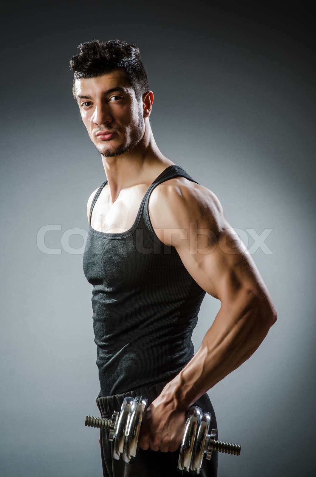 Muscular ripped bodybuilder with dumbbells | Stock image | Colourbox