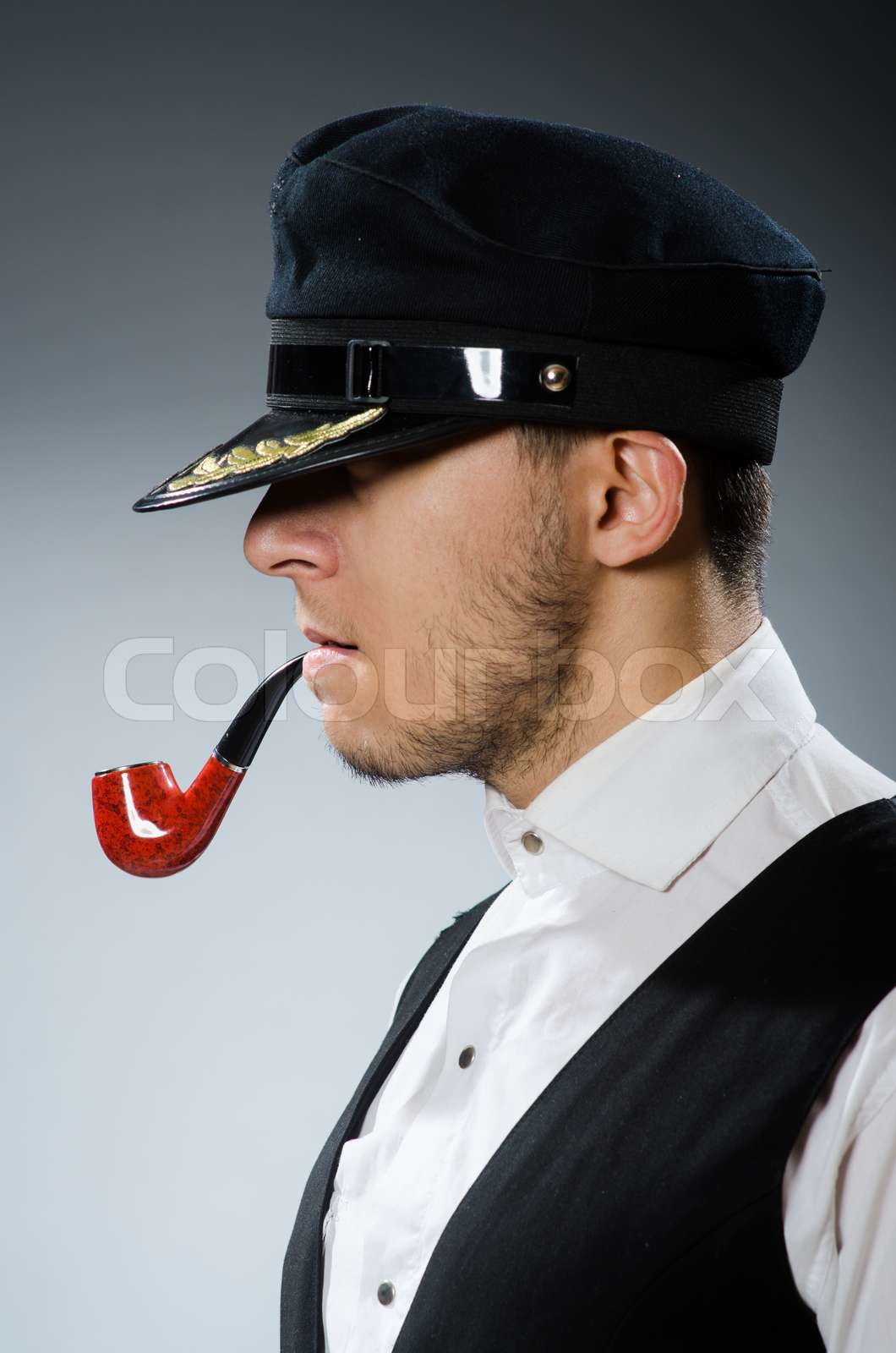 Captain smoking pipe with tobacco | Stock image | Colourbox