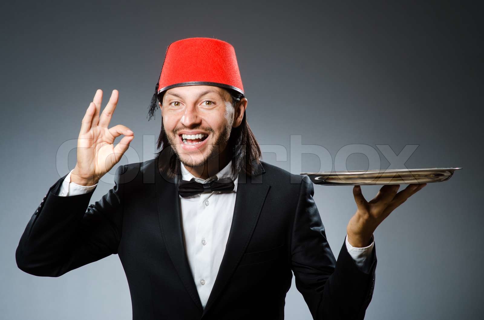 Waiter wearing traditional turkish hat | Stock image | Colourbox