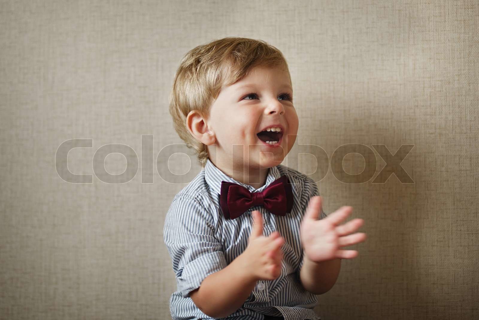 Beautiful little boy laughing and clapping | Stock image | Colourbox