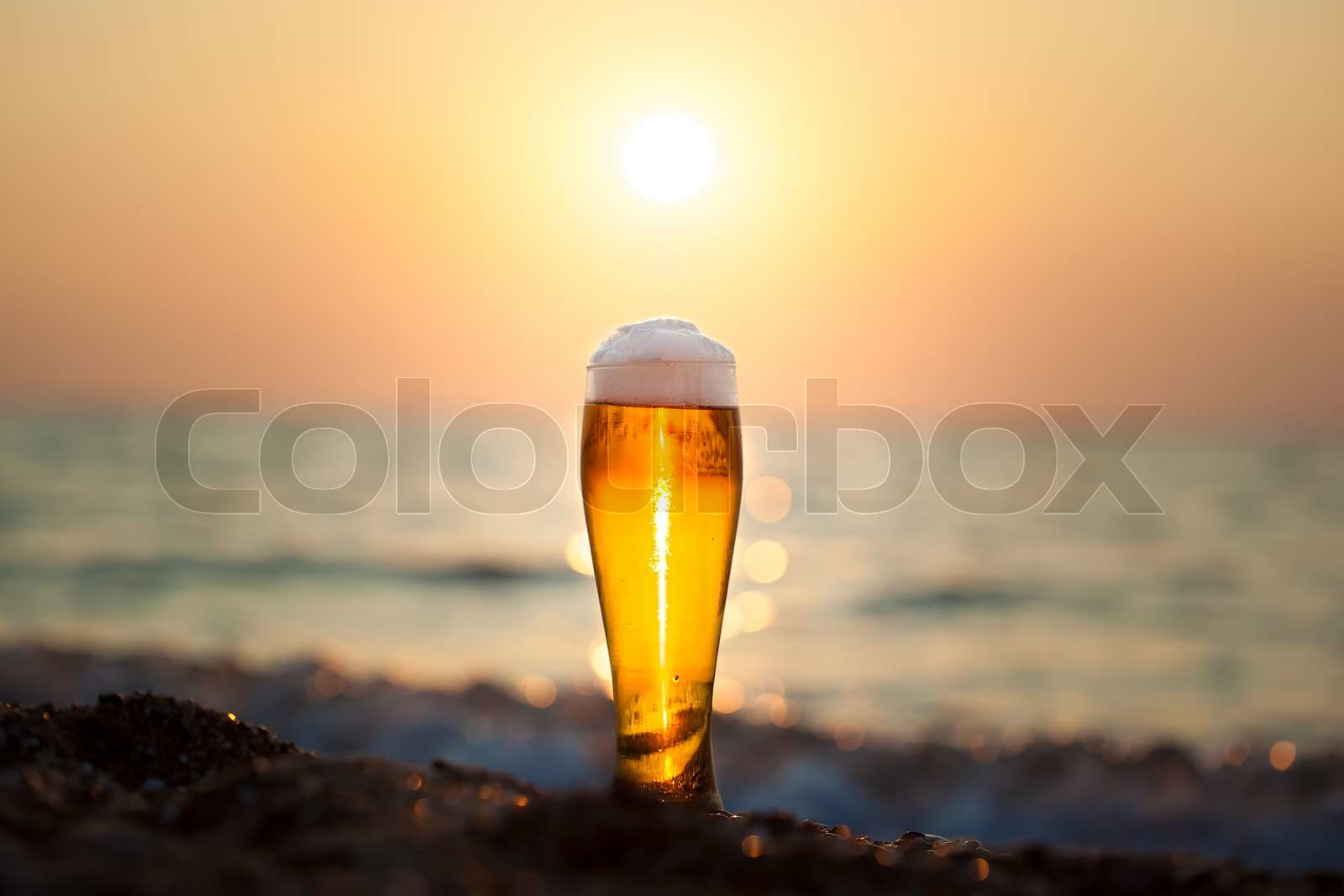 Glass of beer on a sunset | Stock image | Colourbox