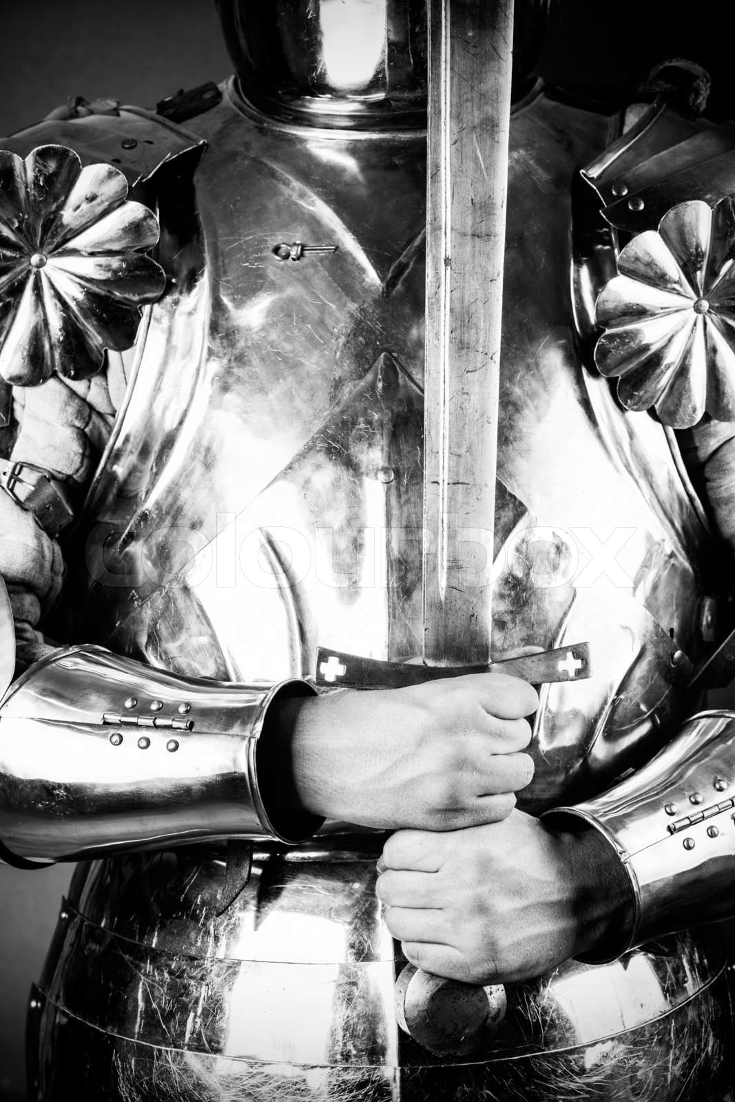 knight wearing armor and holding two-handed sword | Stock image | Colourbox