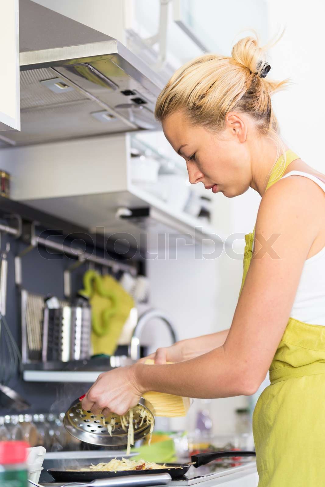 Young Mother Cooking at Home. | Stock image | Colourbox