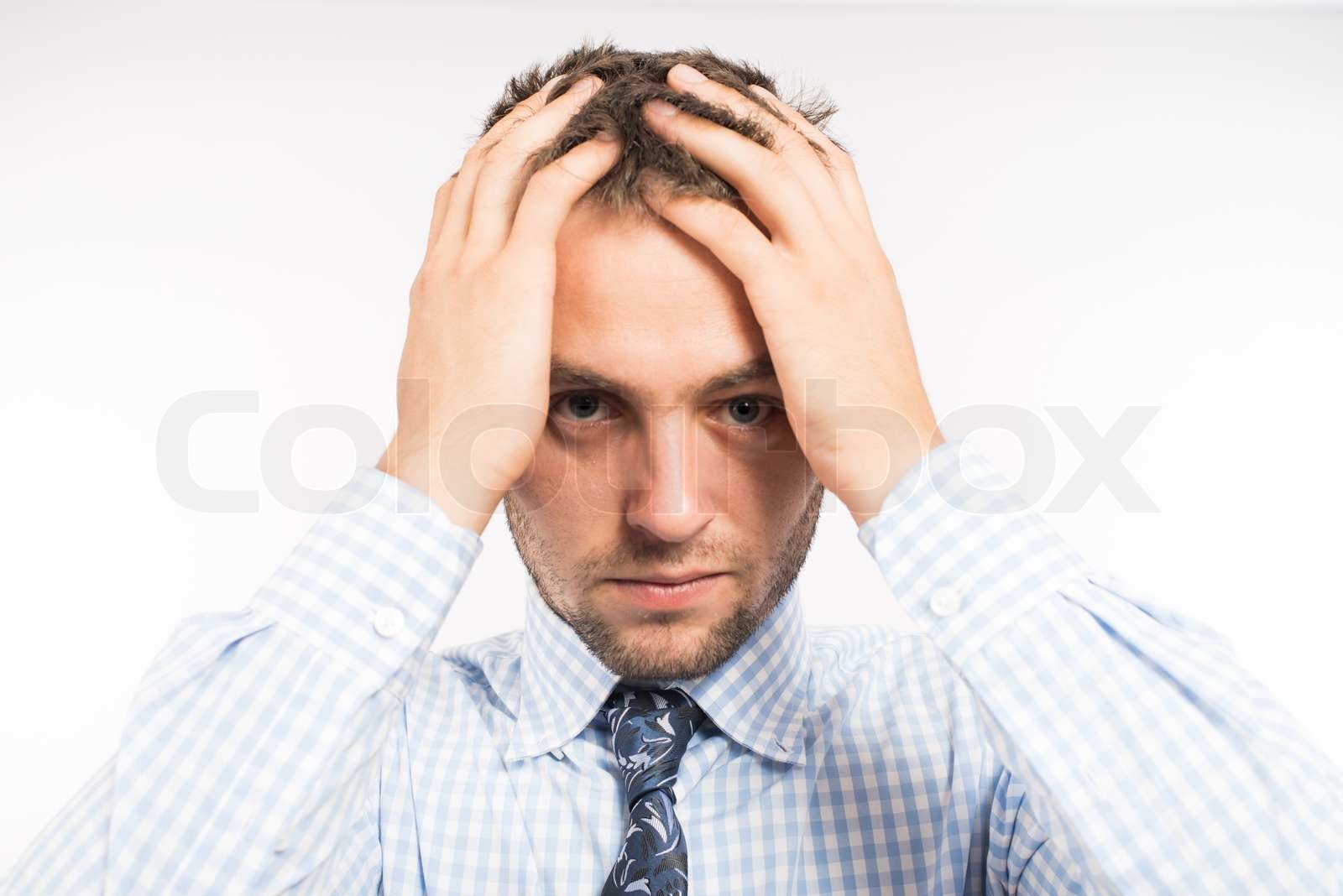 Man holding his head with hands | Stock image | Colourbox