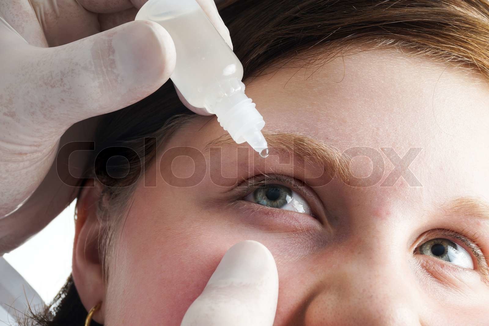 doctor giving a child eye drops | Stock image | Colourbox