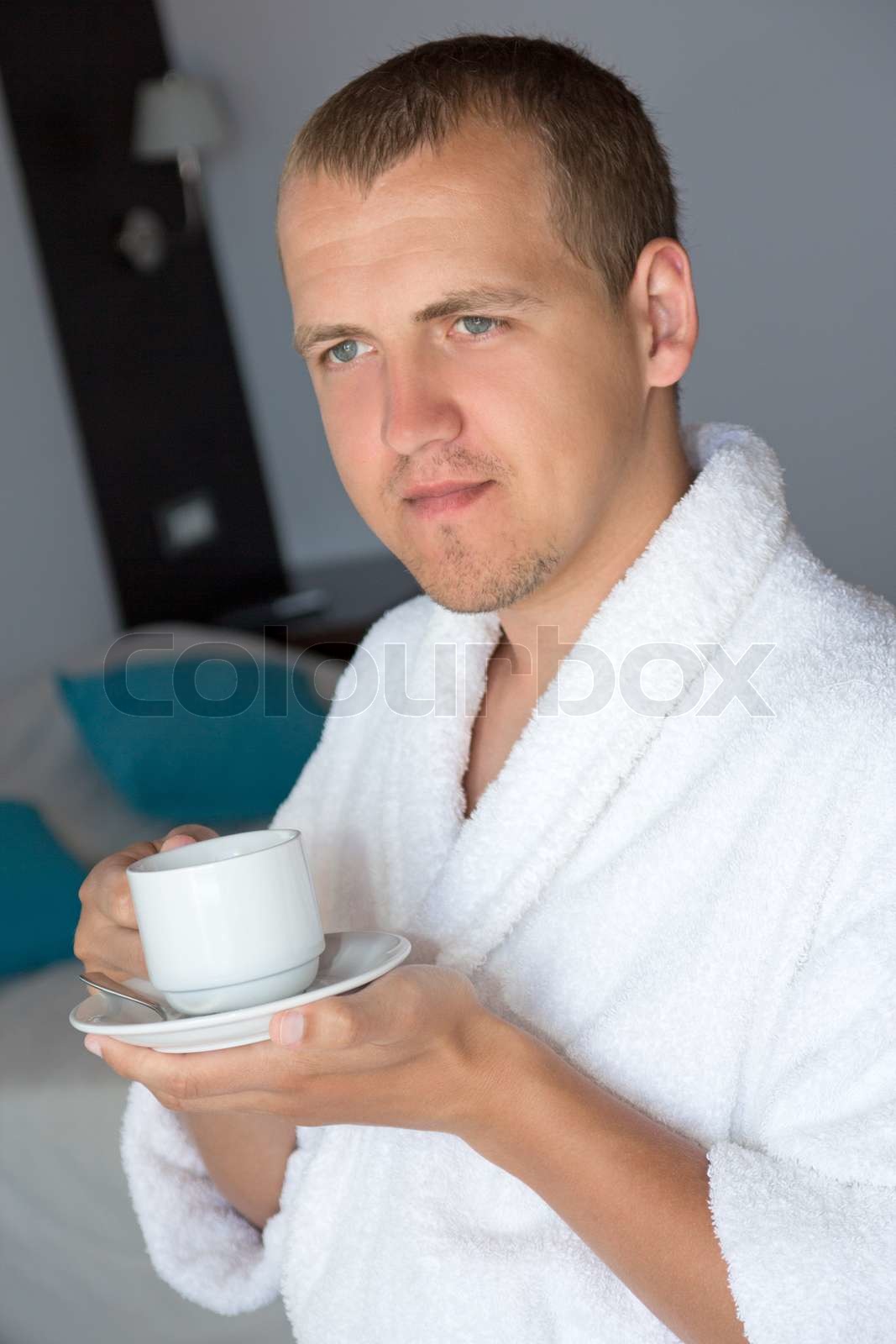 man in bathrobe drinking coffee in hotel room | Stock image | Colourbox