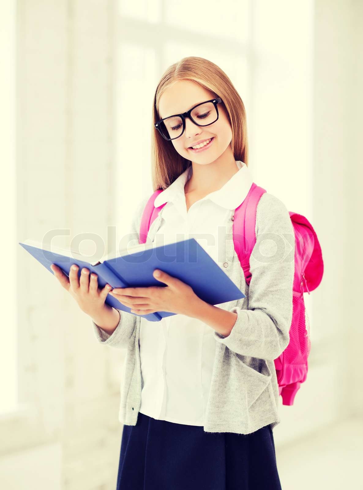 girl reading book at school | Stock image | Colourbox